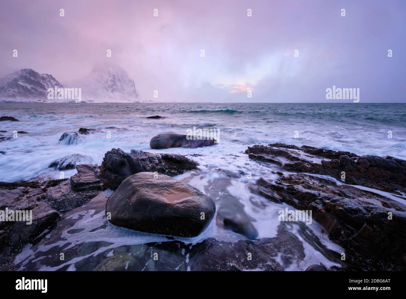 Beach of Norwegian sea on rocky coast in fjord on sunset in winter ...
