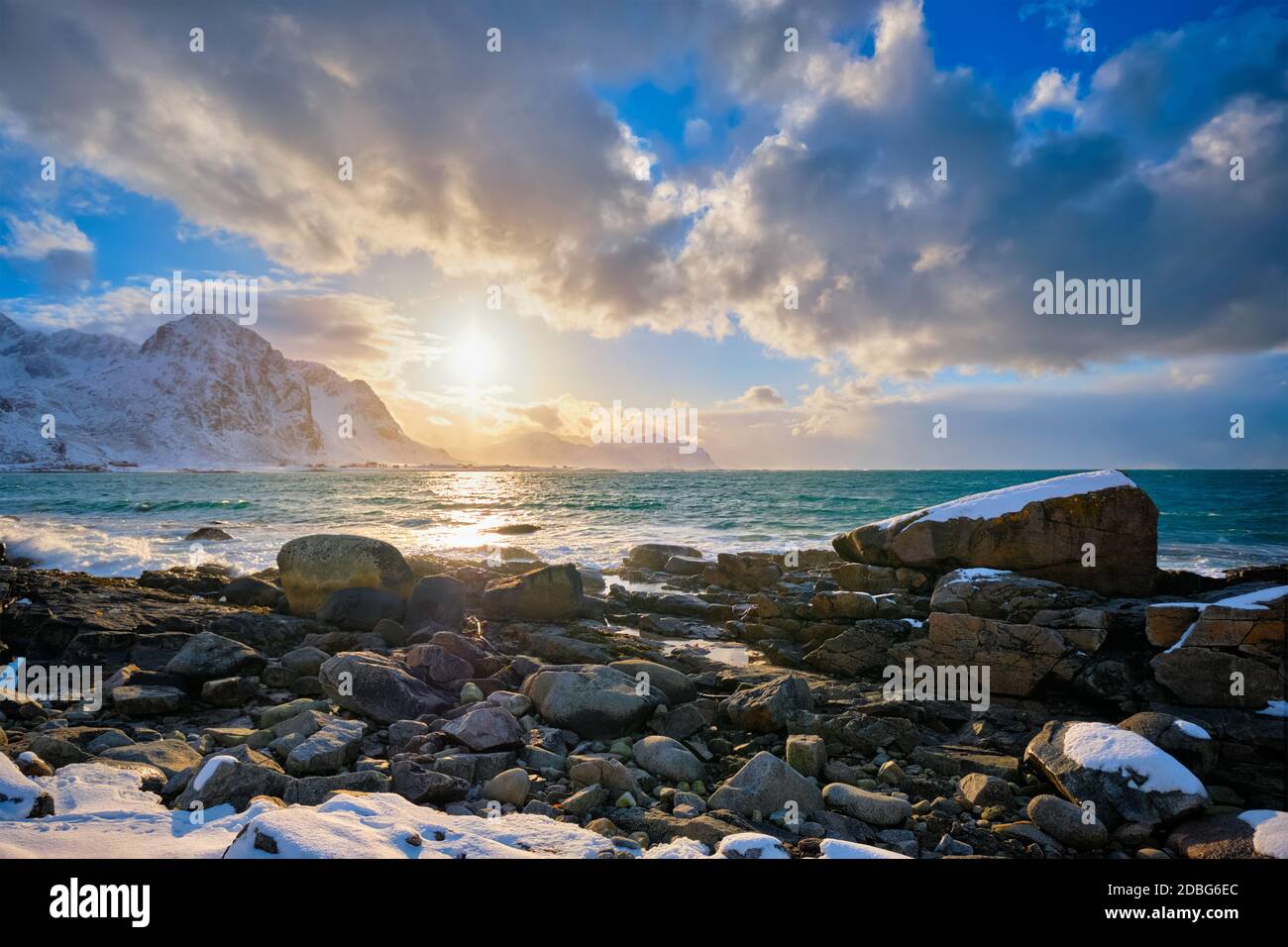 Beach of Norwegian sea on rocky coast in fjord on sunset in winter ...