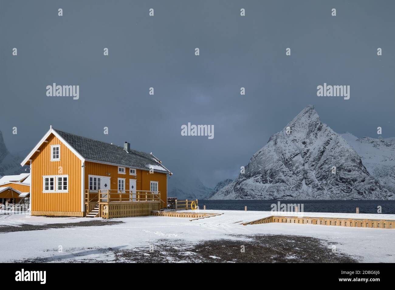 Yellow traditional rorbu house in Sakrisoy fishing village in winter on ...