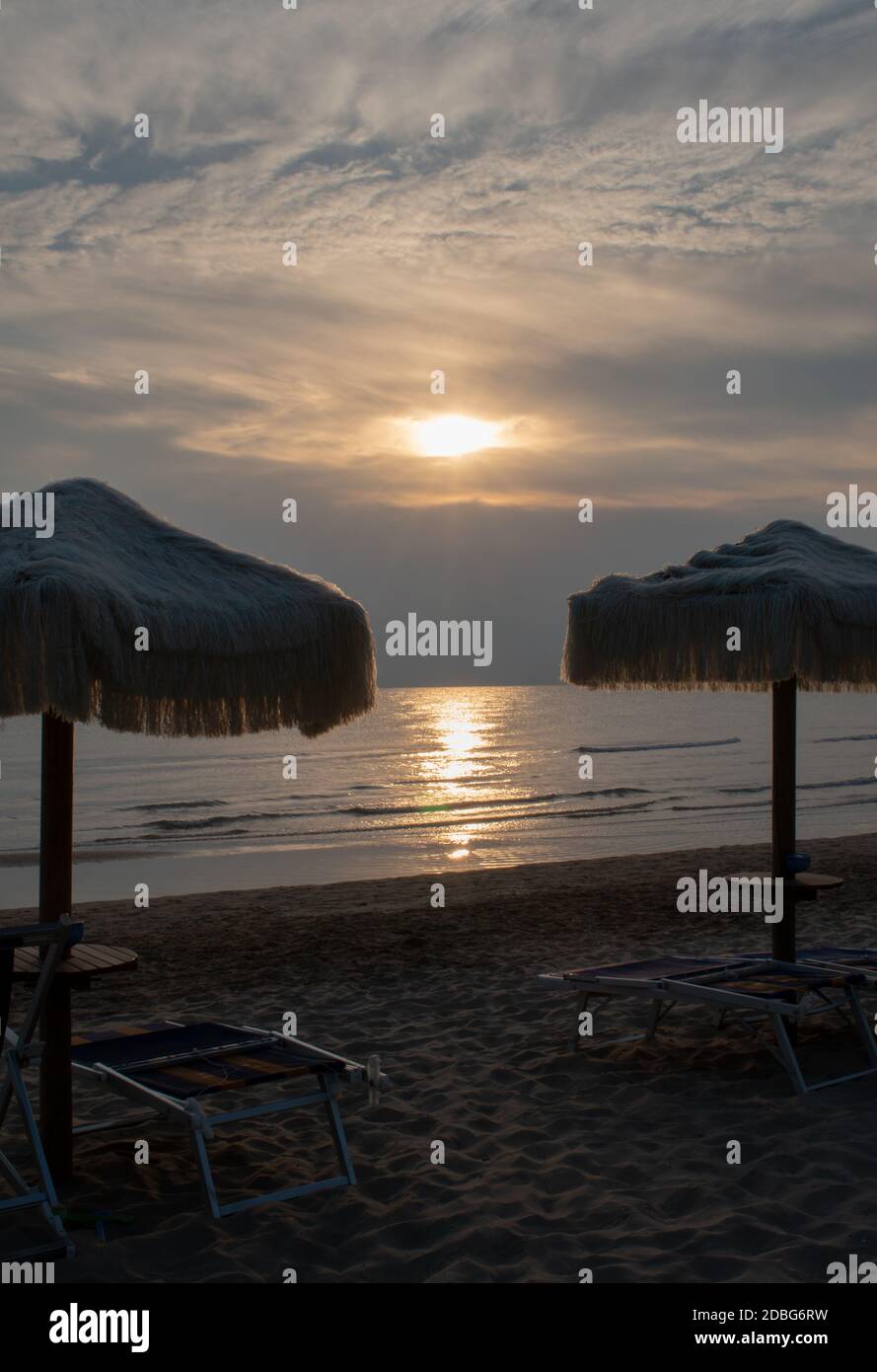 Sunset at the beach with reflection and waves Stock Photo - Alamy
