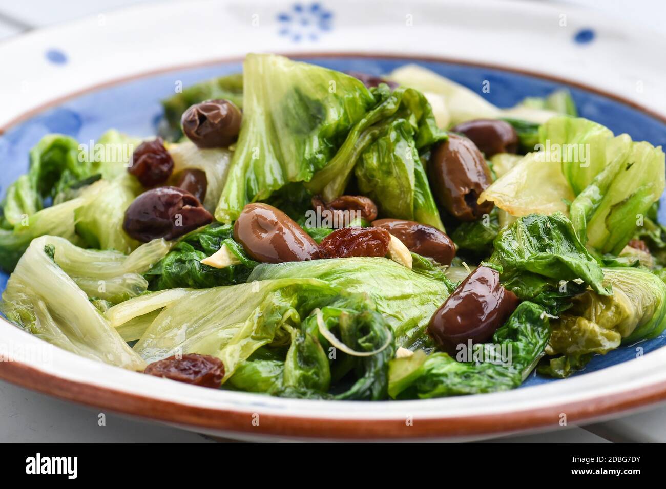 Piatto di scarola,cooked chicory, Vegan diet food, fondo legno, olive ...