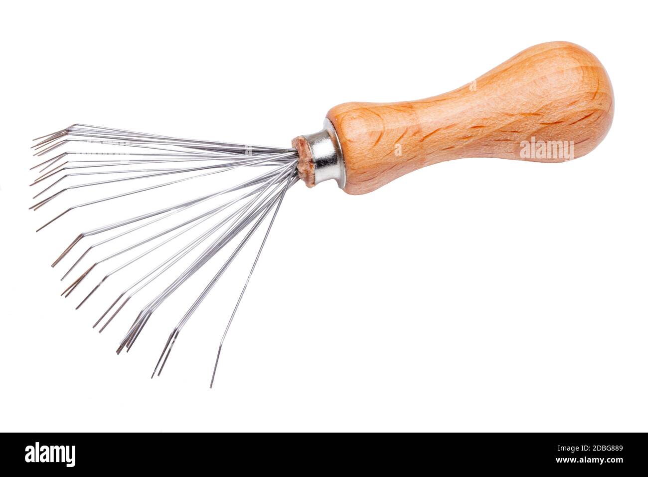 Closeup of a brush and comb cleaner with wooden handle and metal ...
