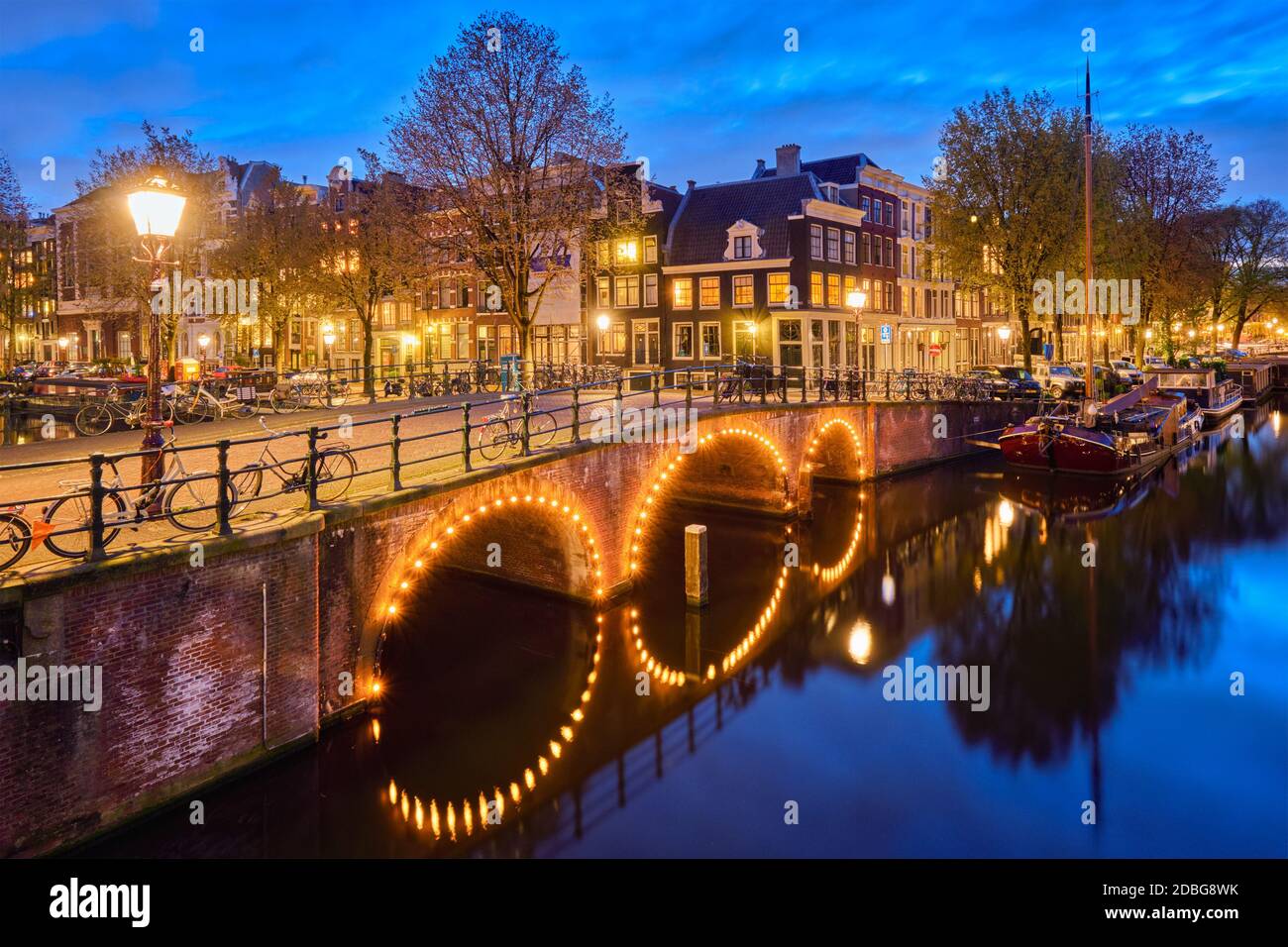 Night view of Amterdam cityscape with canal, bridge and medieval houses ...