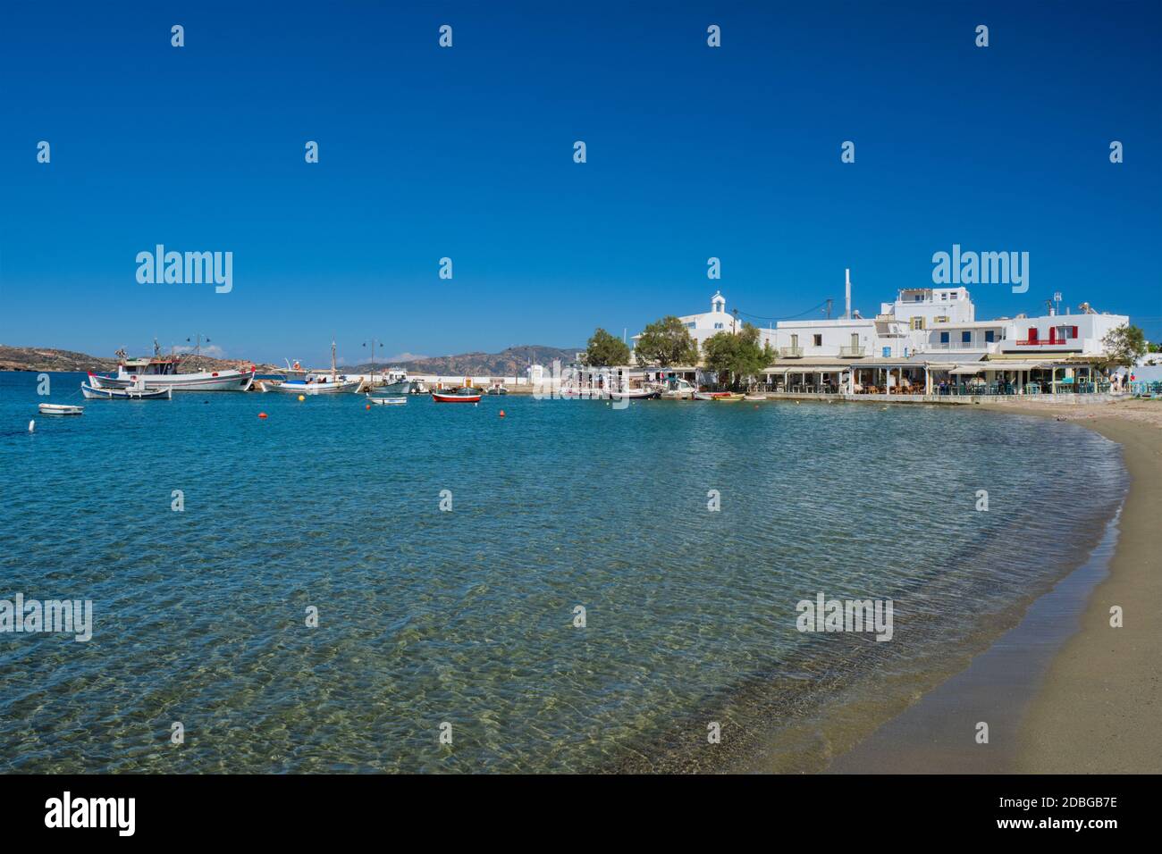 The beach and fishing village of Pollonia with fishing boats in sea ...