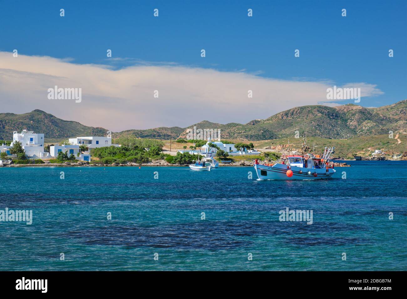 The beach and fishing village of Pollonia with fishing boats in sea ...