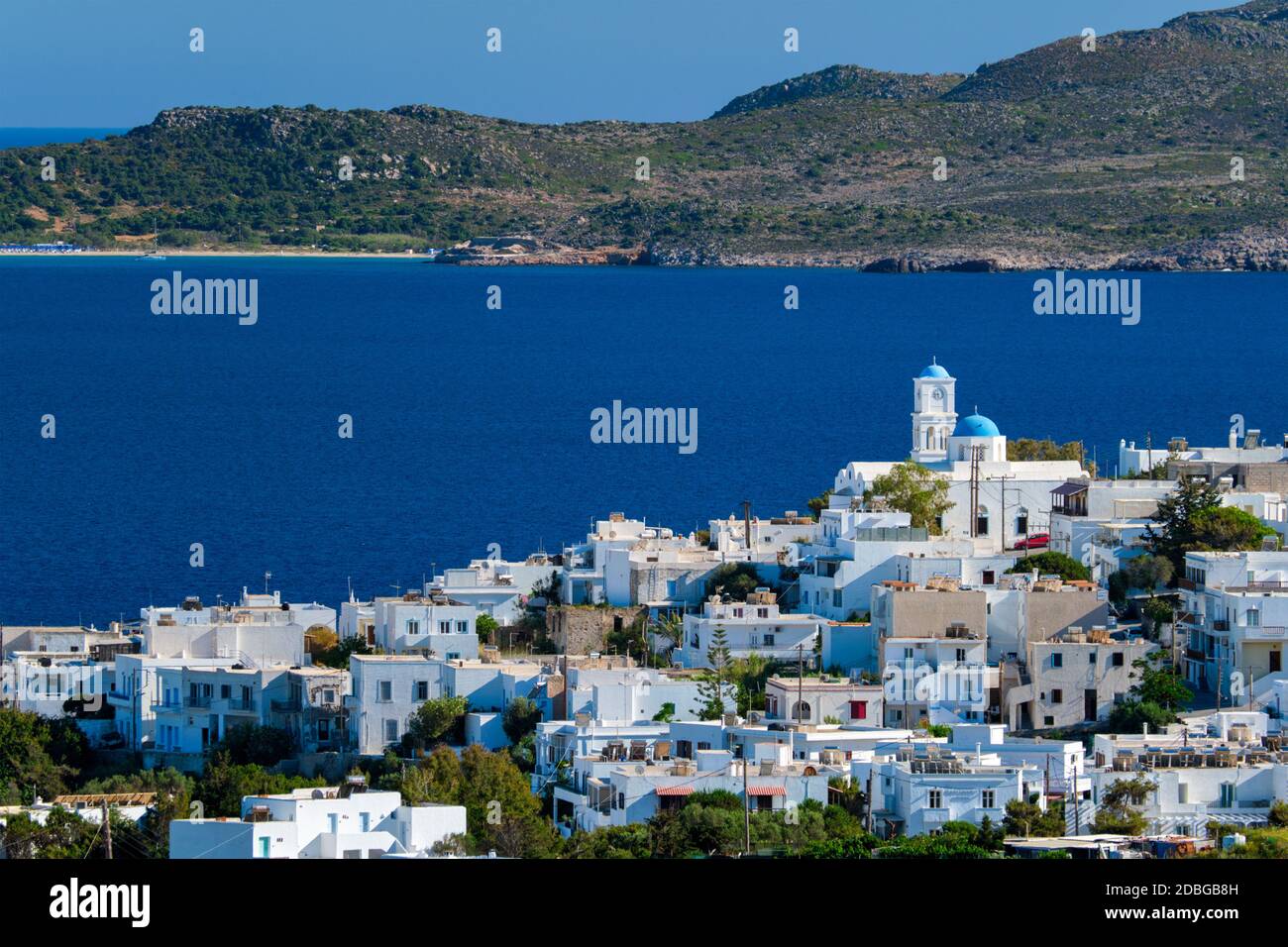View of Plaka village with traditional Greek orthodox church and white ...