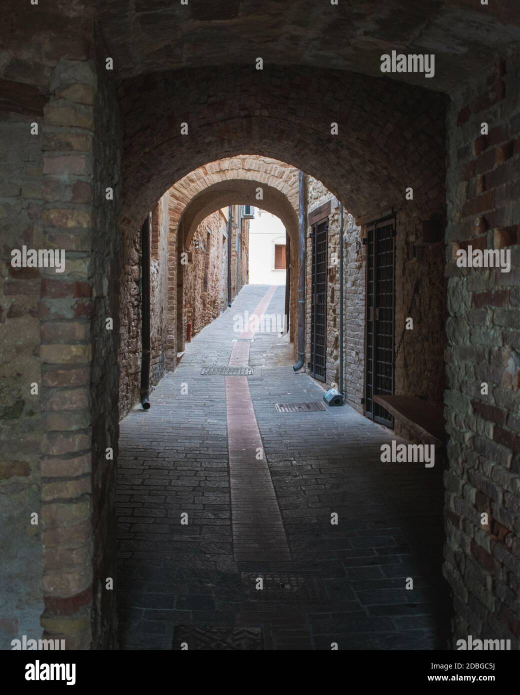 View of tunnel and dark walkway in a medieval burg in Italy Stock Photo ...