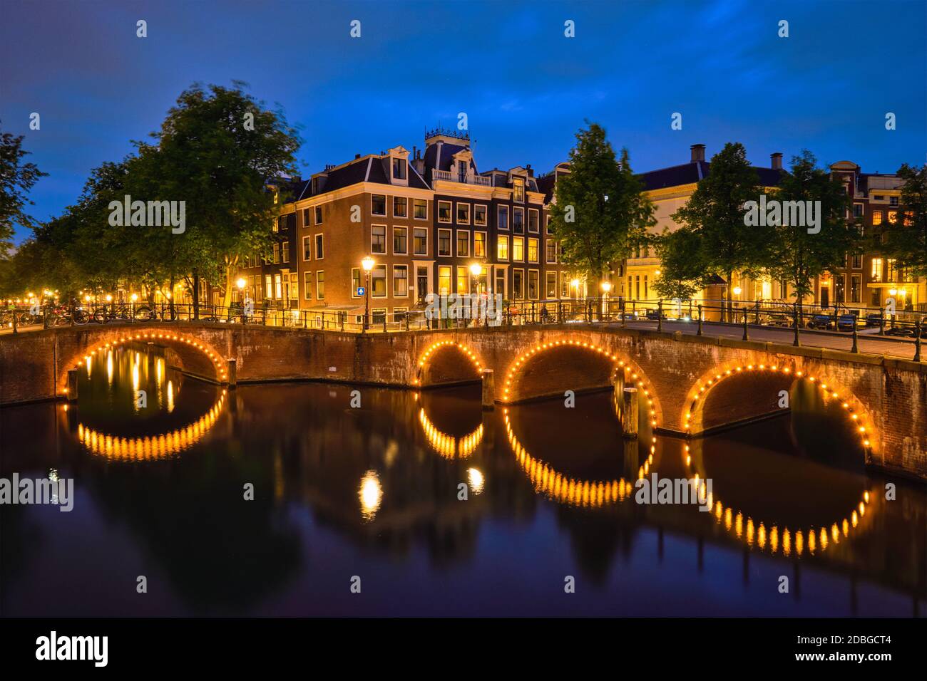 Night view of Amterdam cityscape with canal, bridge and medieval houses ...