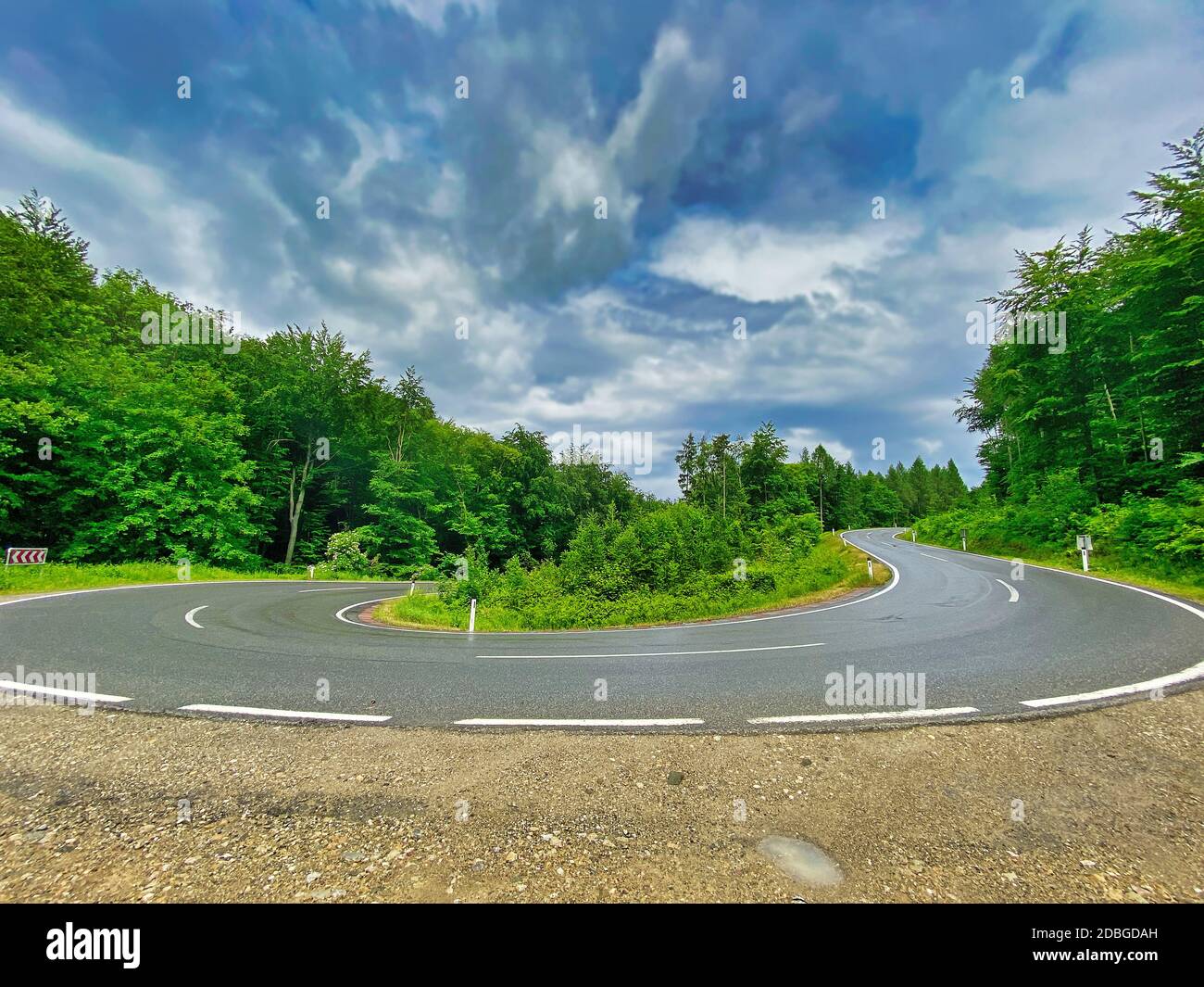 Hairpin Curve Through Forest, street in mountain range with tree area ...