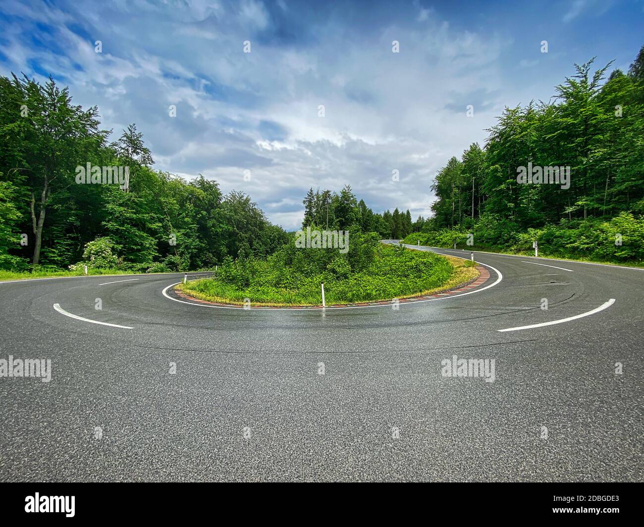 Hairpin Curve Through Forest, street in mountain range with tree area ...
