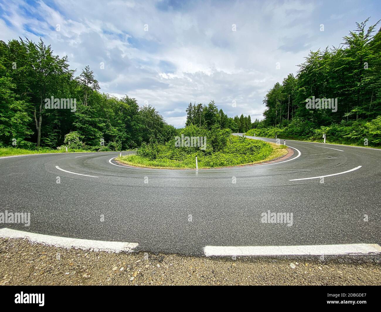 Hairpin Curve Through Forest, street in mountain range with tree area ...