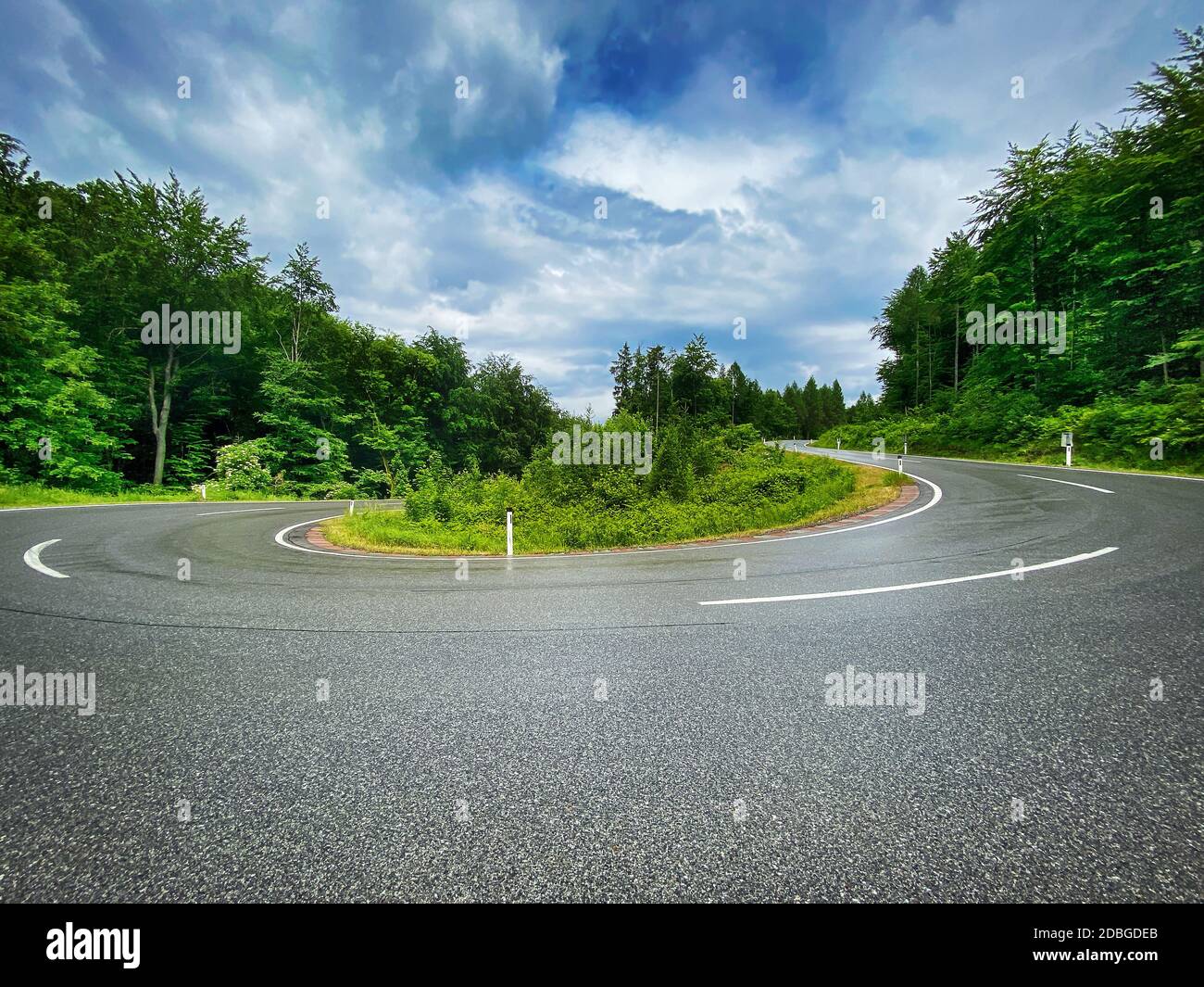 Hairpin Curve Through Forest, street in mountain range with tree area ...