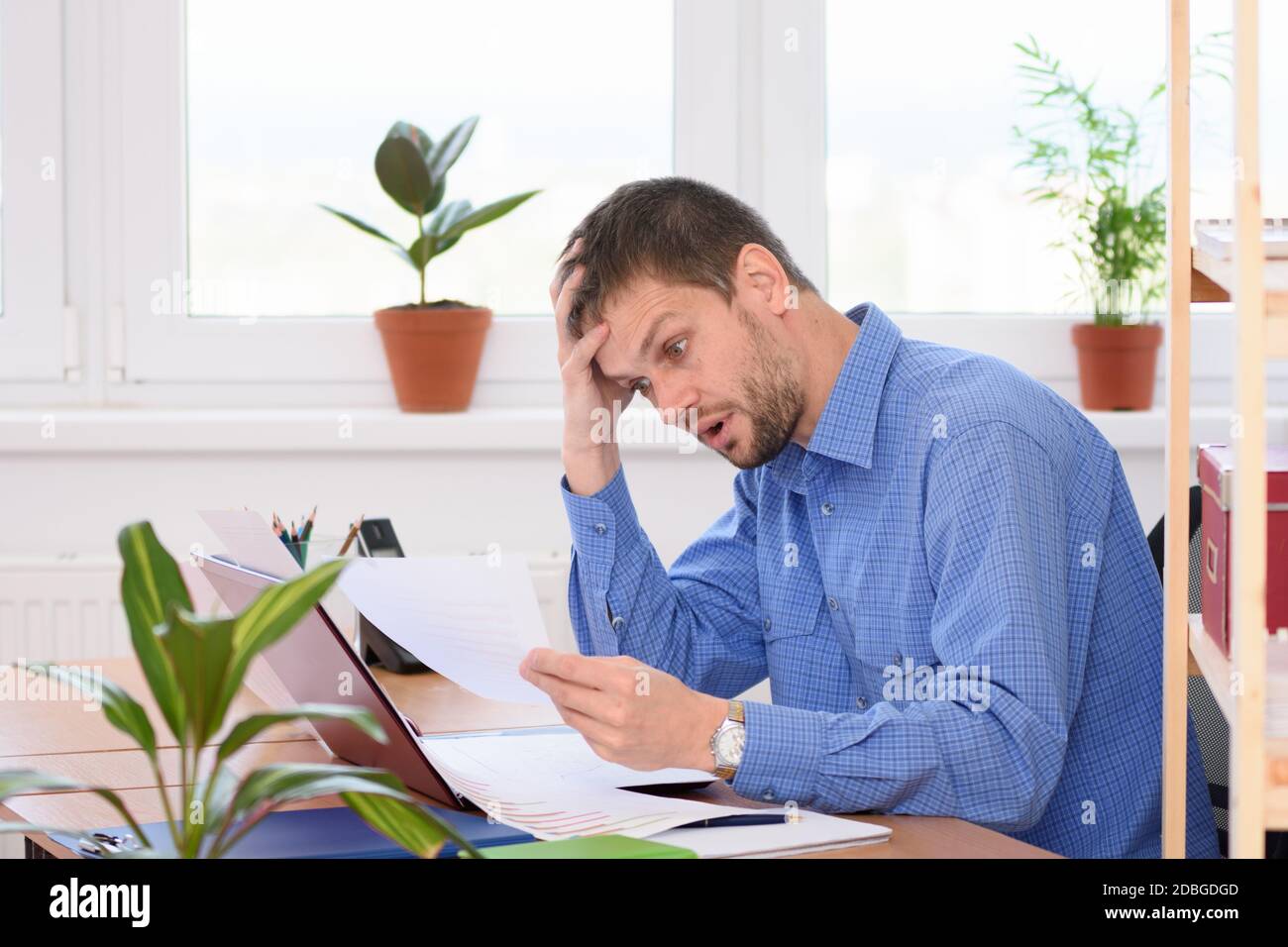 Office clerk horrified by what is written in the document Stock Photo ...