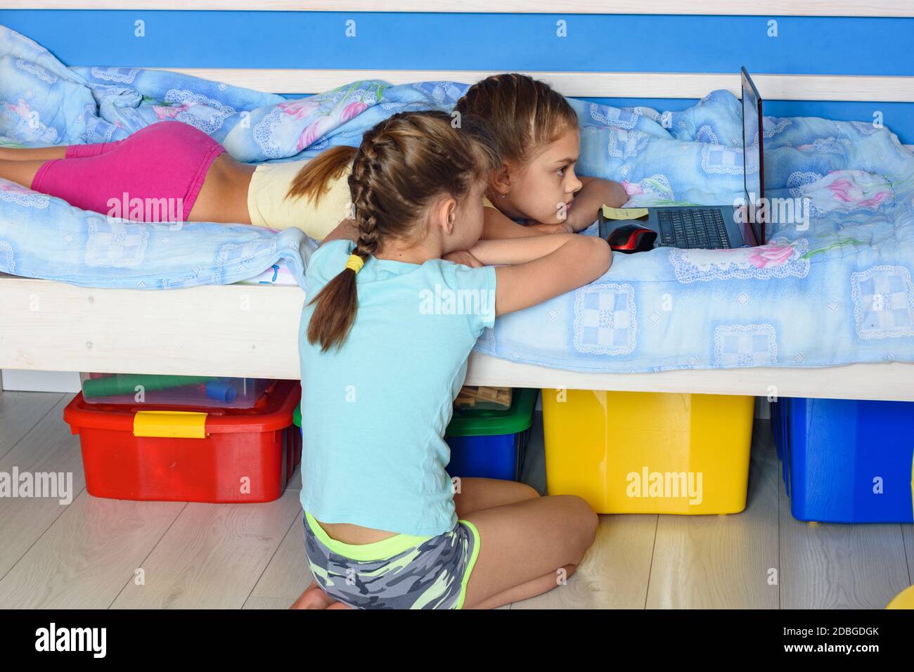 Children watch cartoons on a laptop screen Stock Photo - Alamy