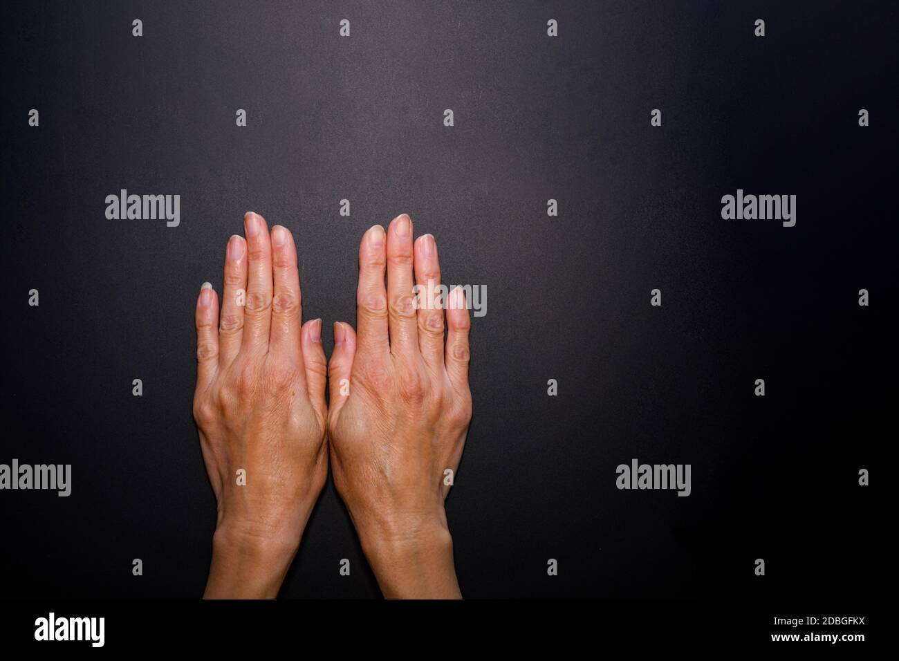 Hand on black background Stock Photo - Alamy