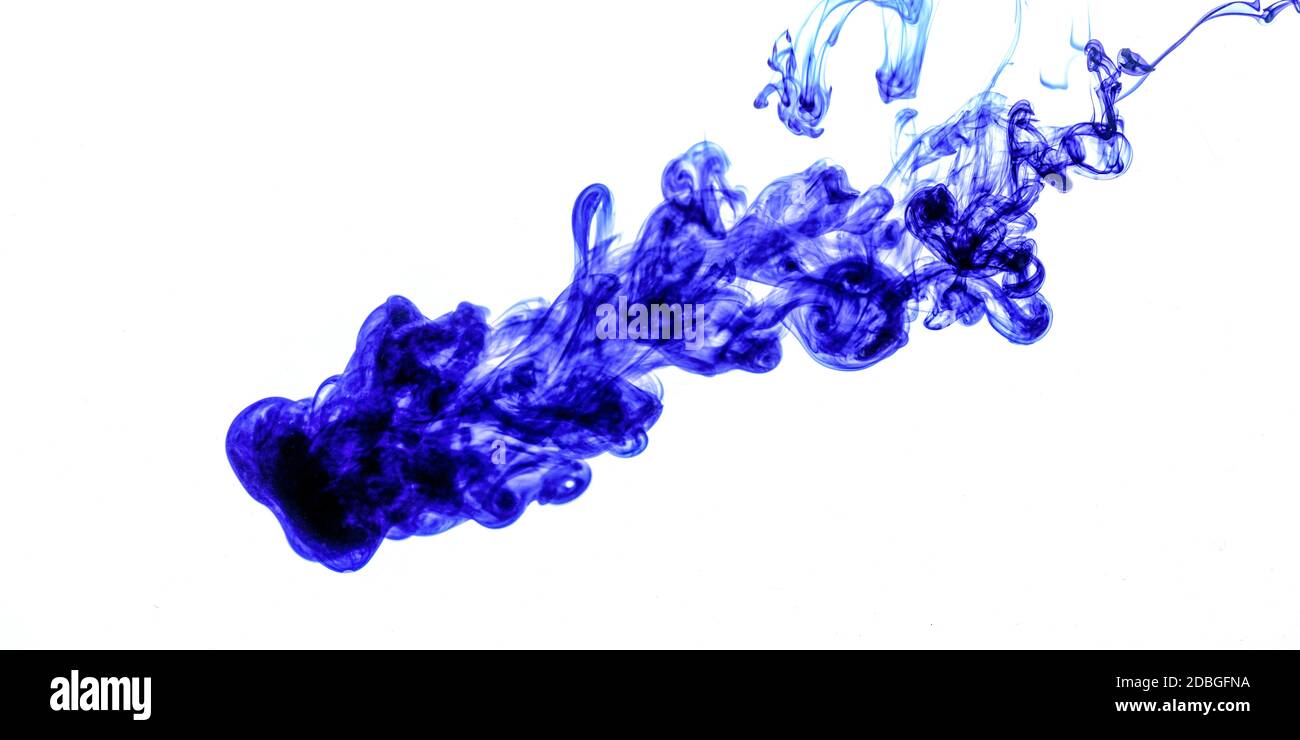 Blue ink injected into water from syringe, colour mixing with water ...