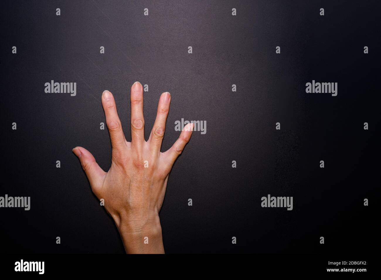 Hand on black background Stock Photo - Alamy