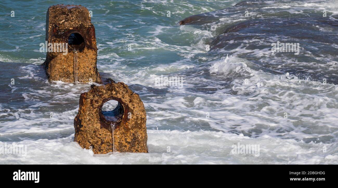 a rocks with holes in the port Stock Photo - Alamy