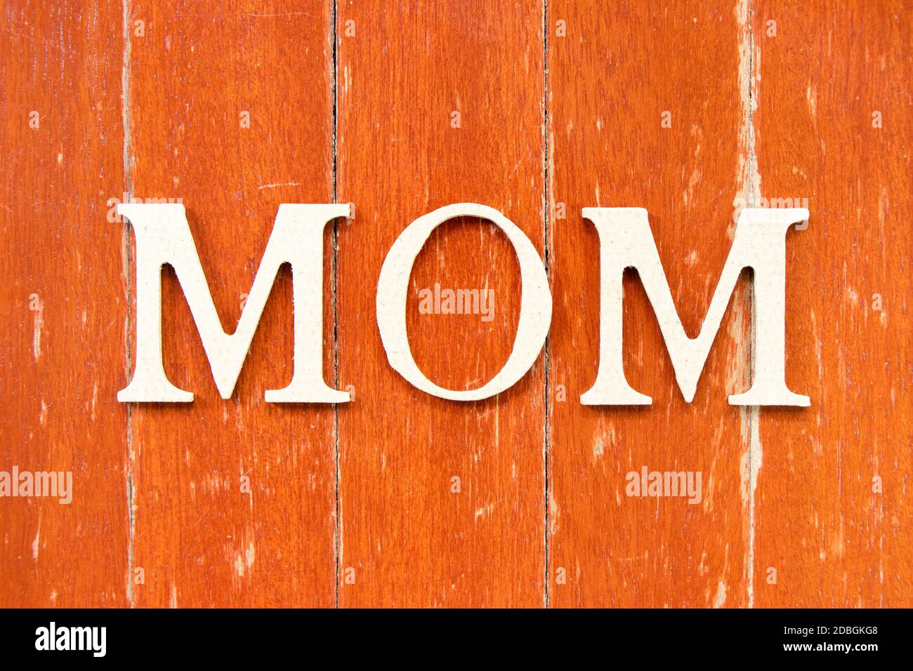 Alphabet letter in word mom on old red color wood plate background ...