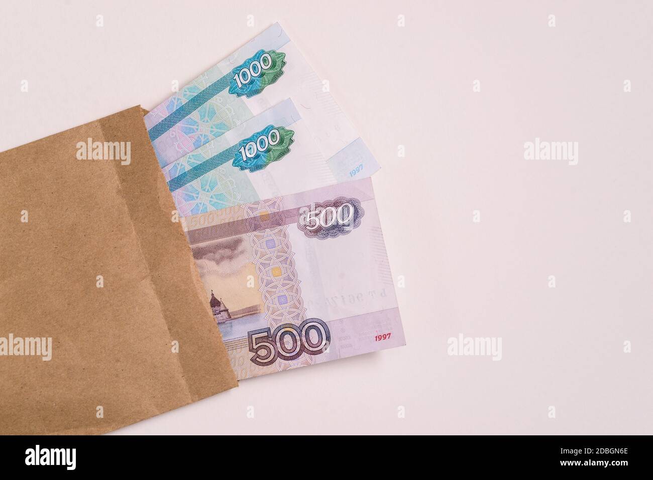 Stack of cash Russian money and an envelope on a white background ...