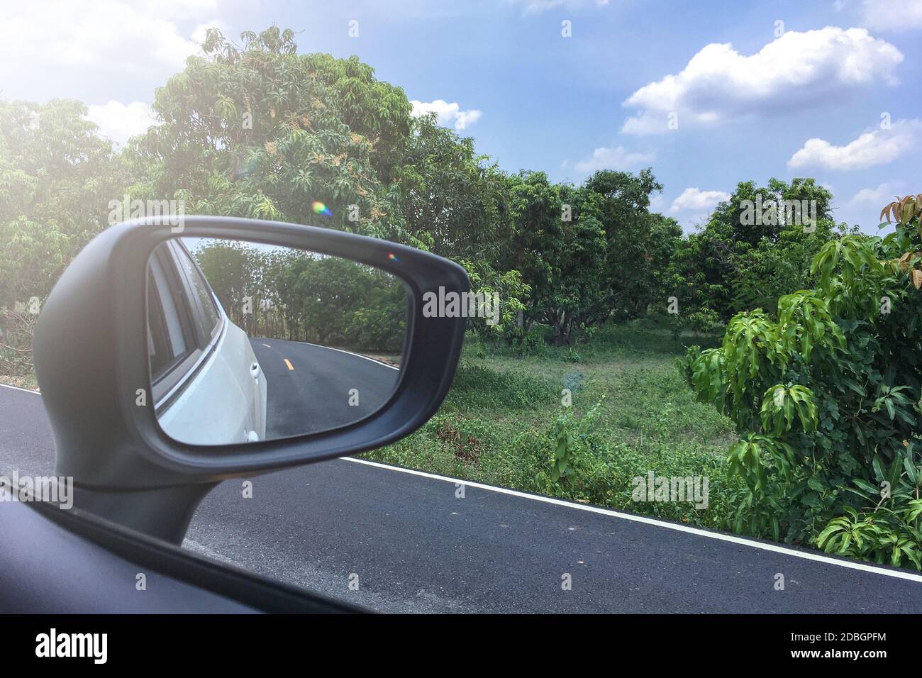 Landscape in the sideview mirror of a car , on road countryside ...