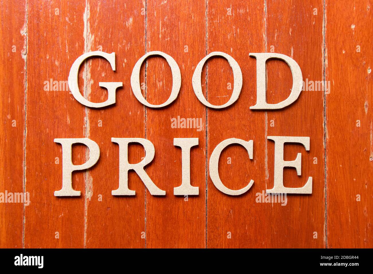 Alphabet letter in word good price on old red color wood plate ...