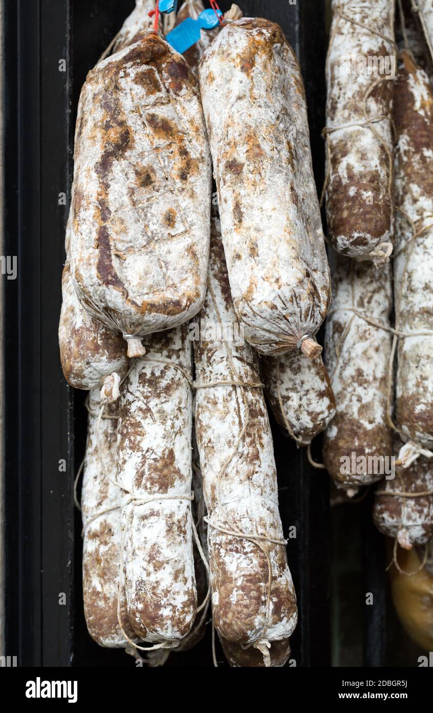 Different variety of italian salami hanging on a delicatessen shop ...
