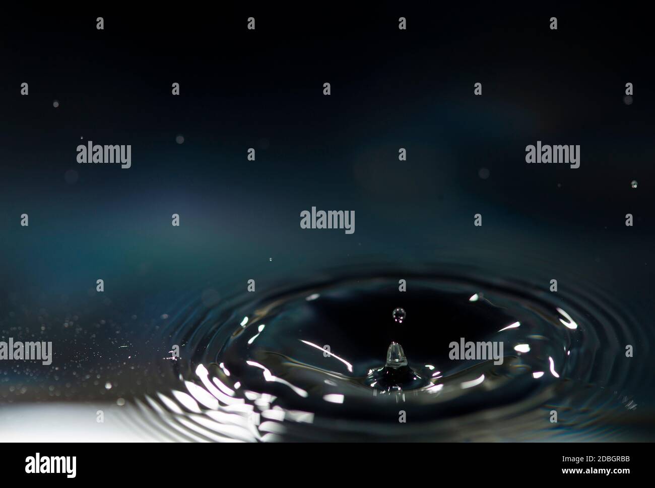 A studio high speed flash of water dropping into water Stock Photo - Alamy