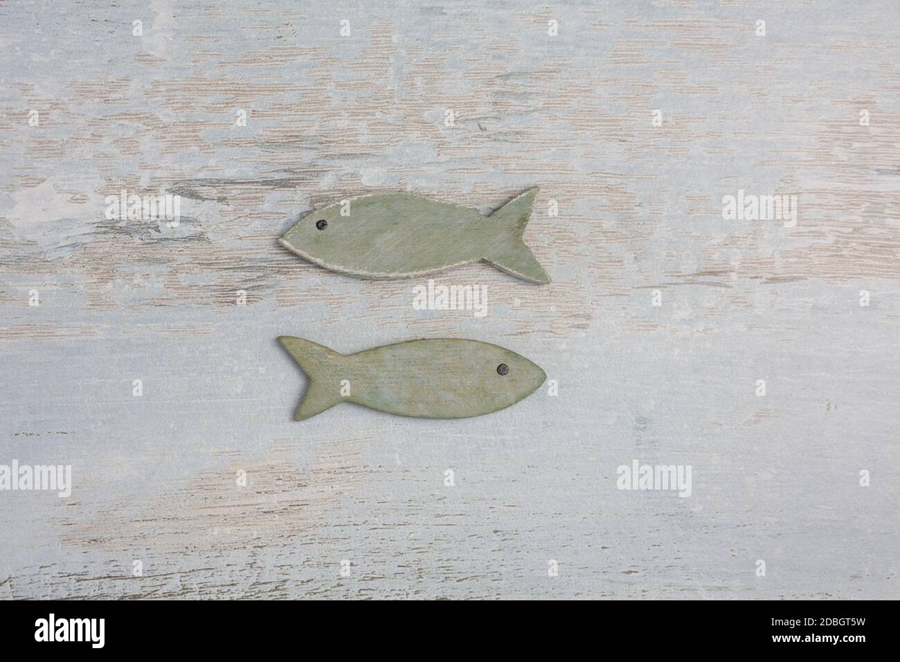 two little fish on wooden textured background with copy space, perfect ...