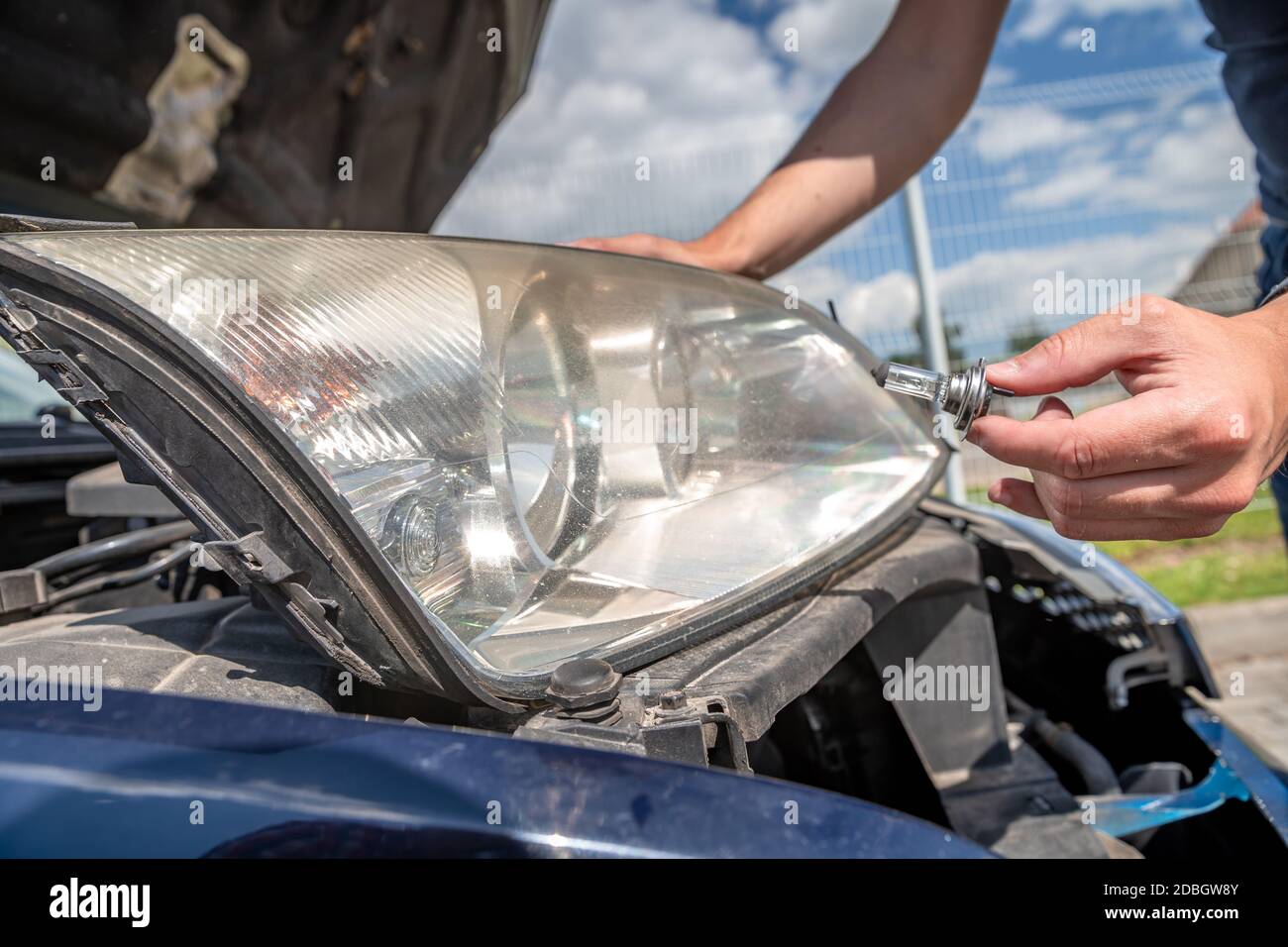 car headlight repair by replacing bad bulbs with new ones Stock Photo ...
