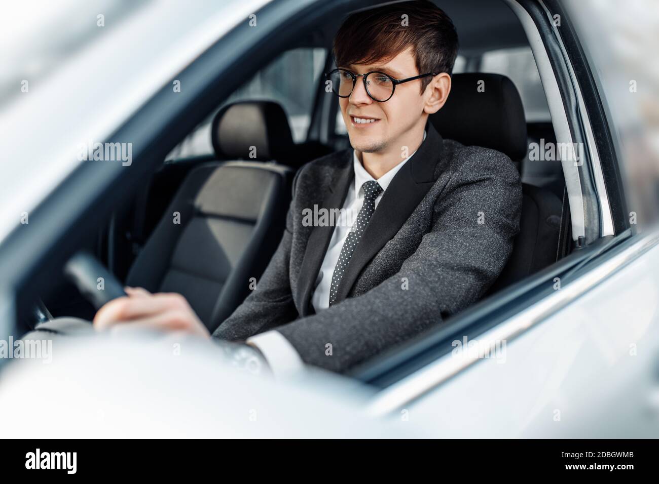 Business young businessman driving a car, going to work Stock Photo - Alamy