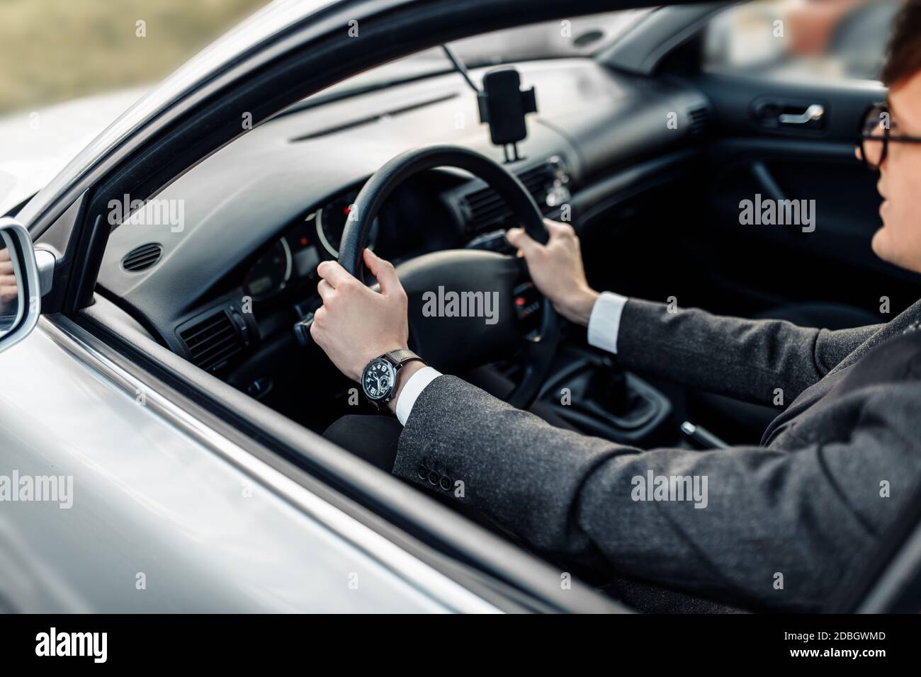 Business young businessman driving a car, going to work Stock Photo - Alamy