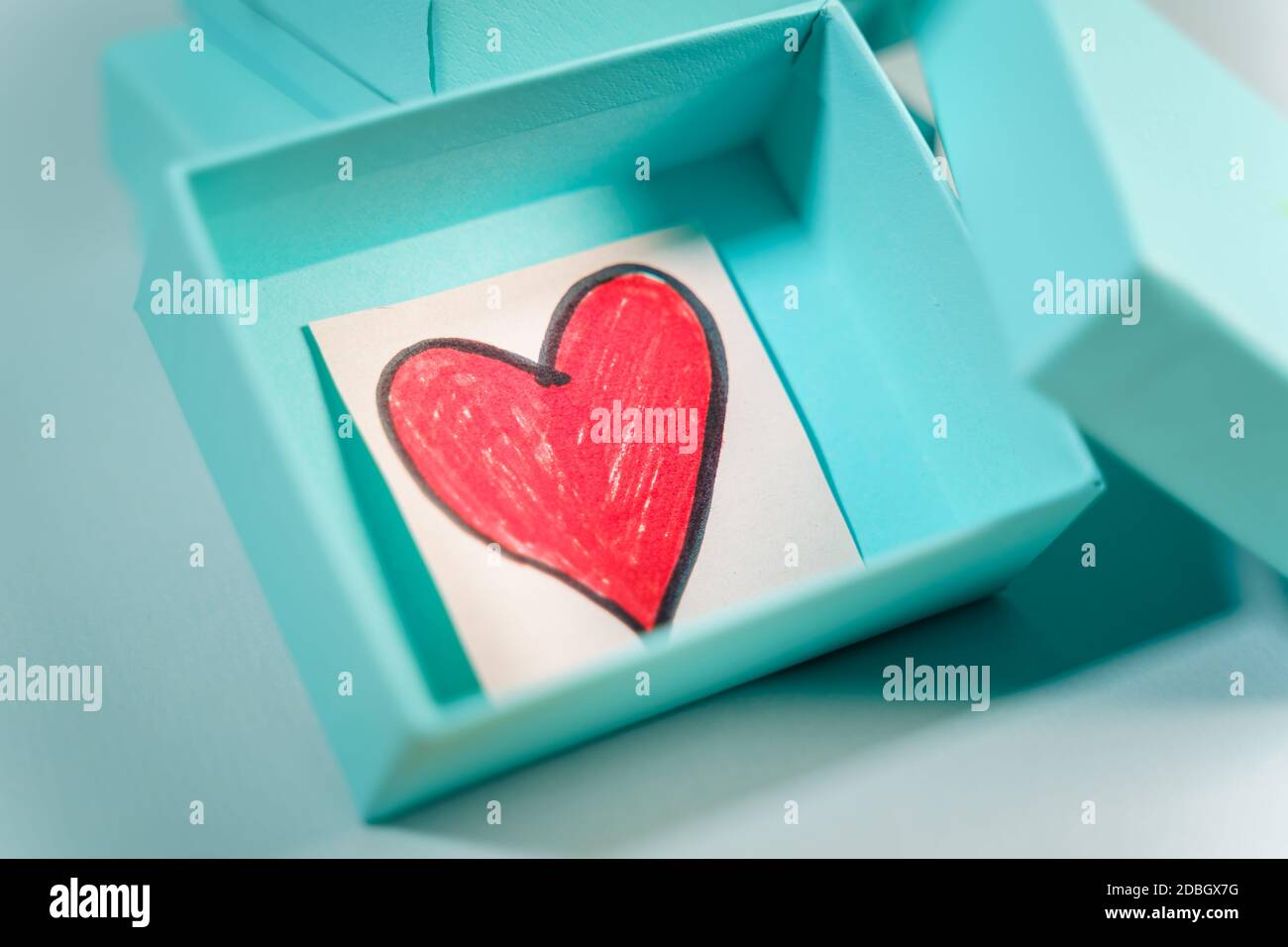 Heart drawn inside a turquoise gift box Stock Photo - Alamy