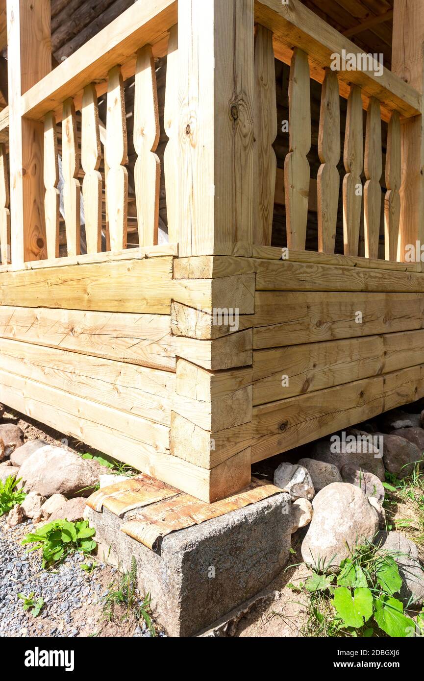 Corner of the wooden house on the support stone foundation Stock Photo ...