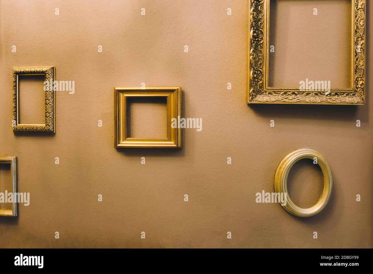 Empty golden luxury frames on vintage design wall, space for text ...