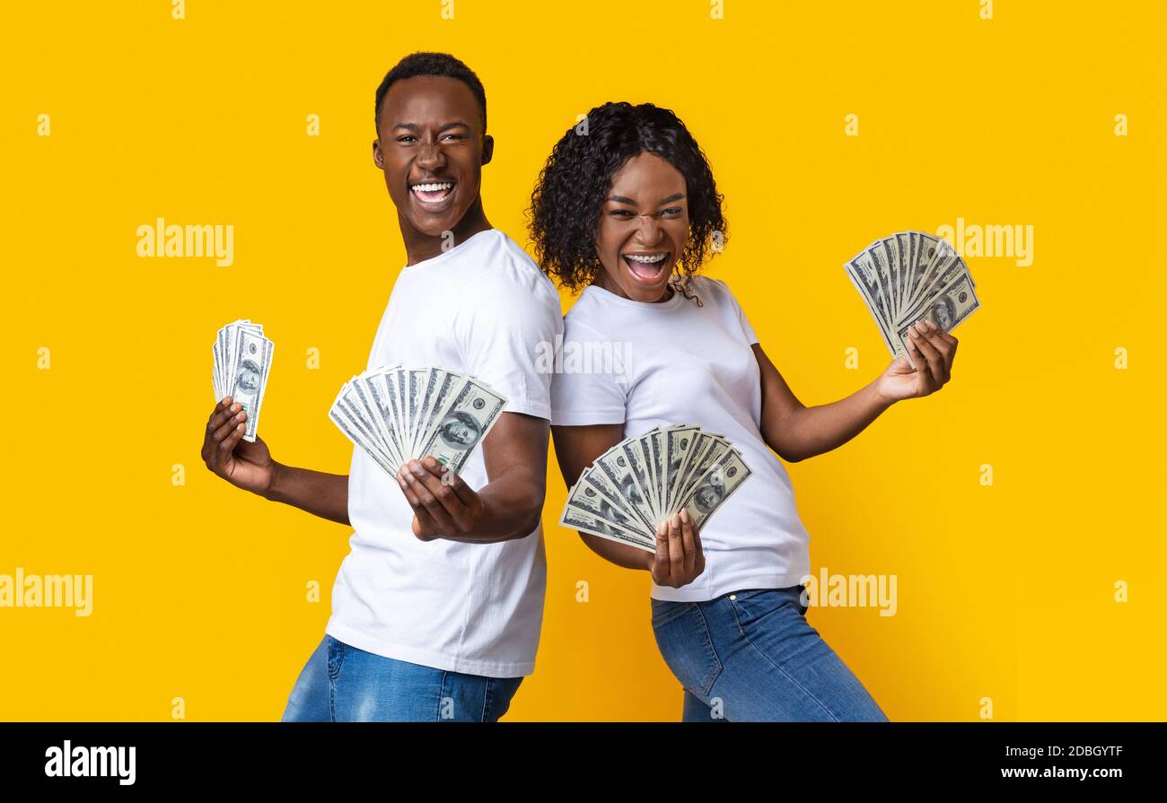 Emotional black couple dancing with bunch of money banknotes Stock ...