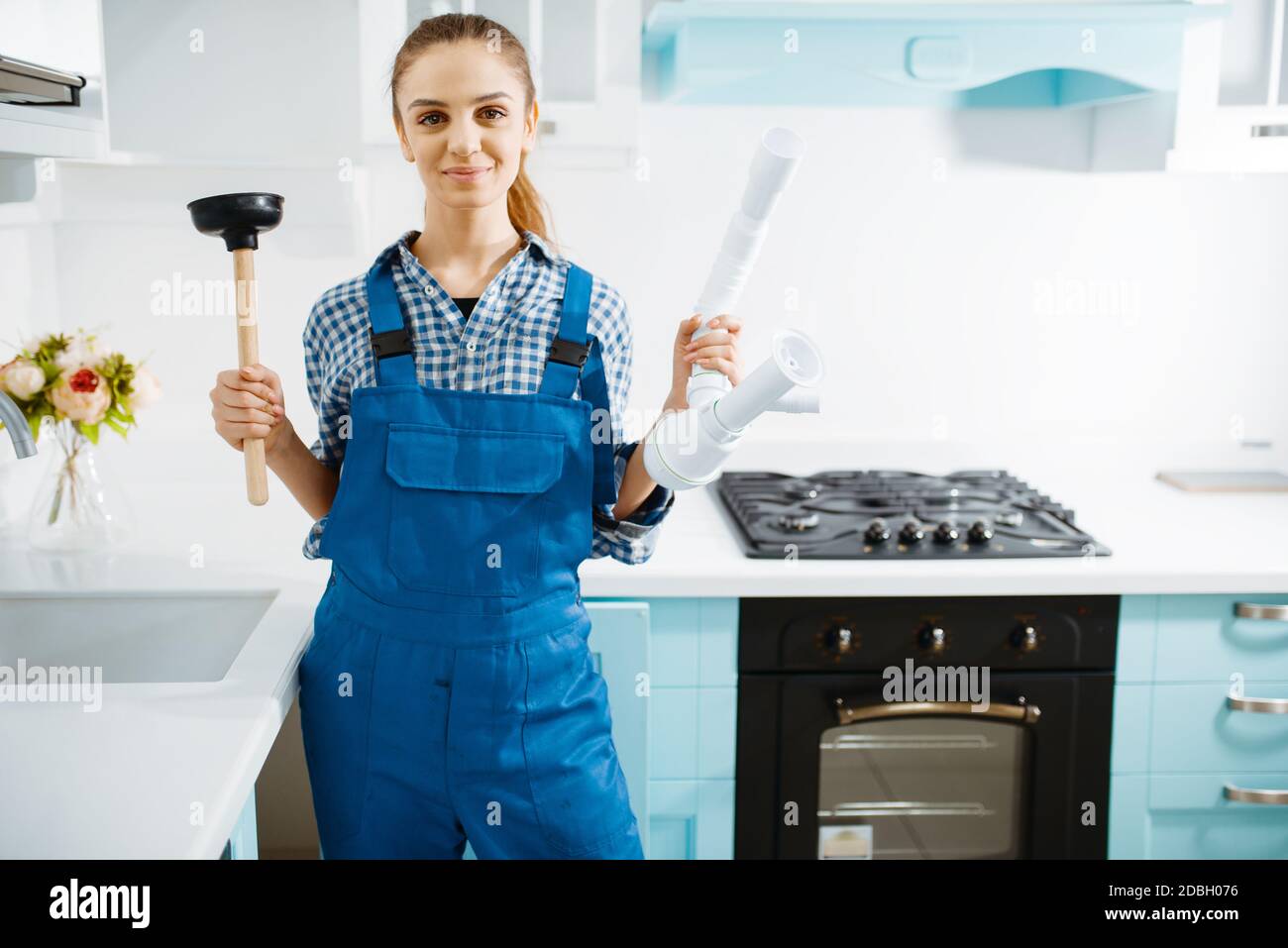 Cute female plumber in uniform holds plunger and pipe, clog in the ...