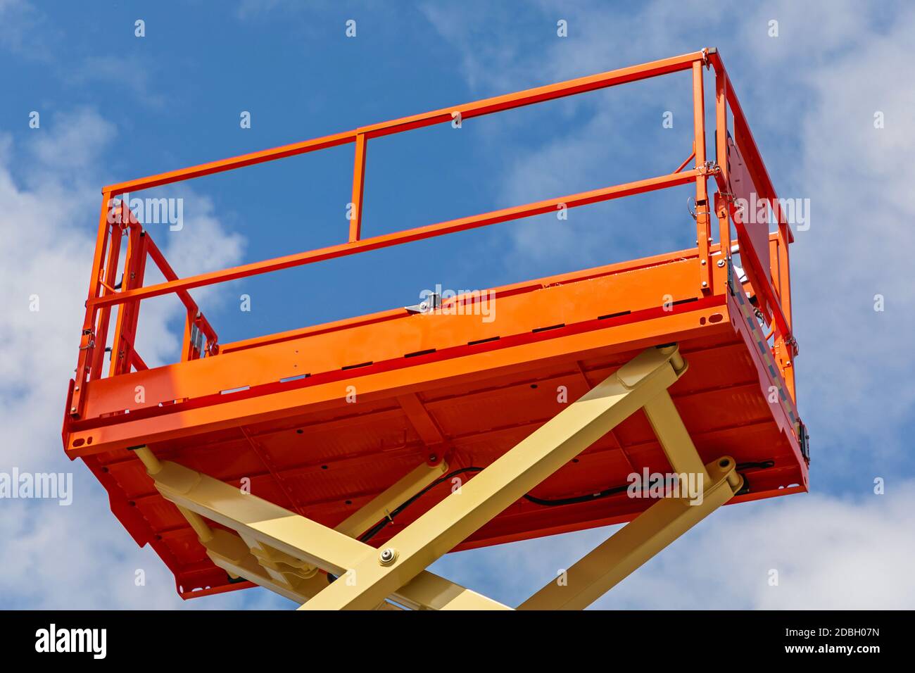 Tall scissor lift platform machine at construction site hi-res stock ...