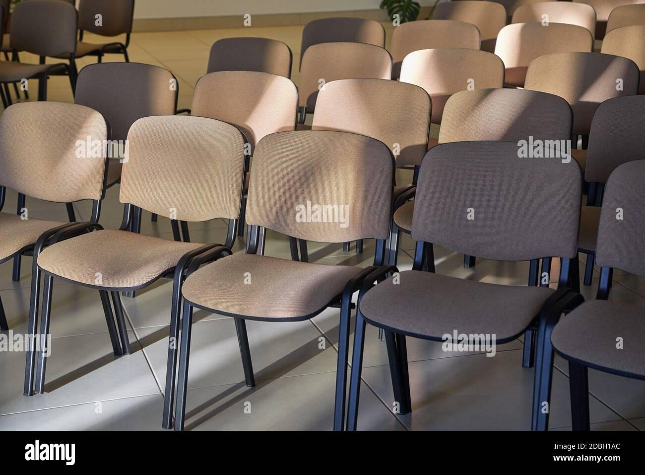 Chairs in rows in an empty autditorium, nobody around Stock Photo - Alamy