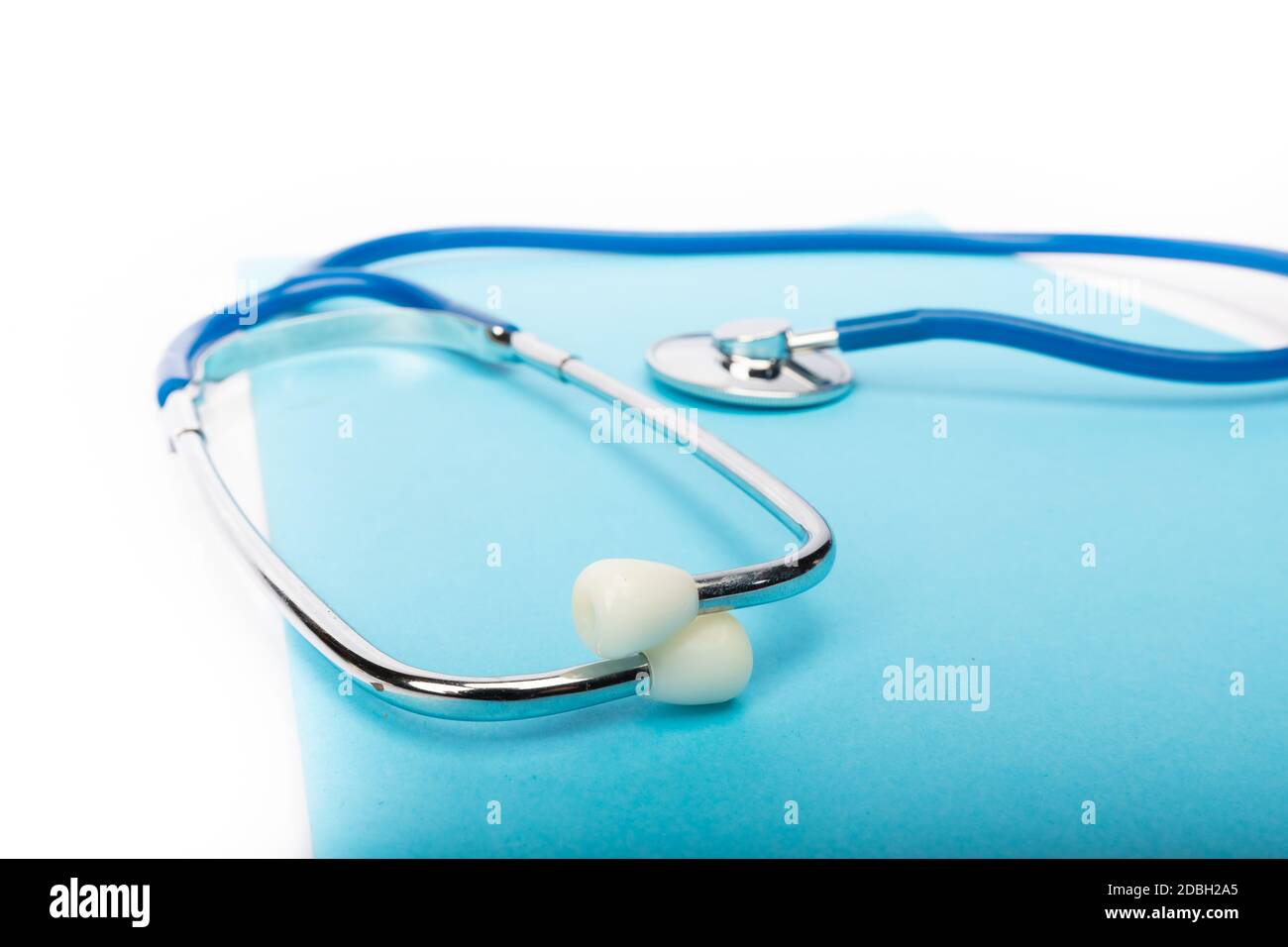 medical record and blue stethoscope close-up on white background in ...