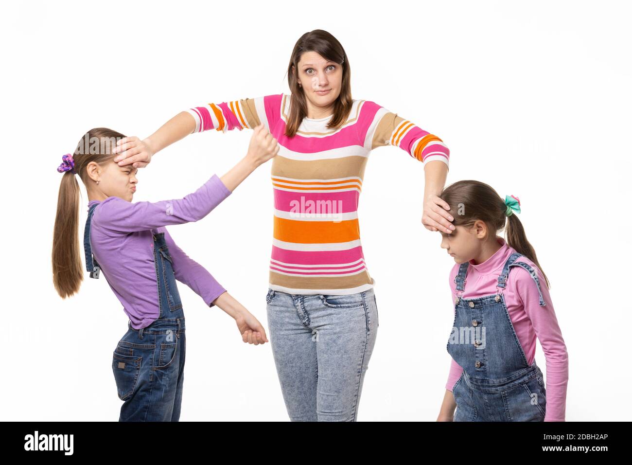 Girl trying to separate the fighting children, isolated on white ...