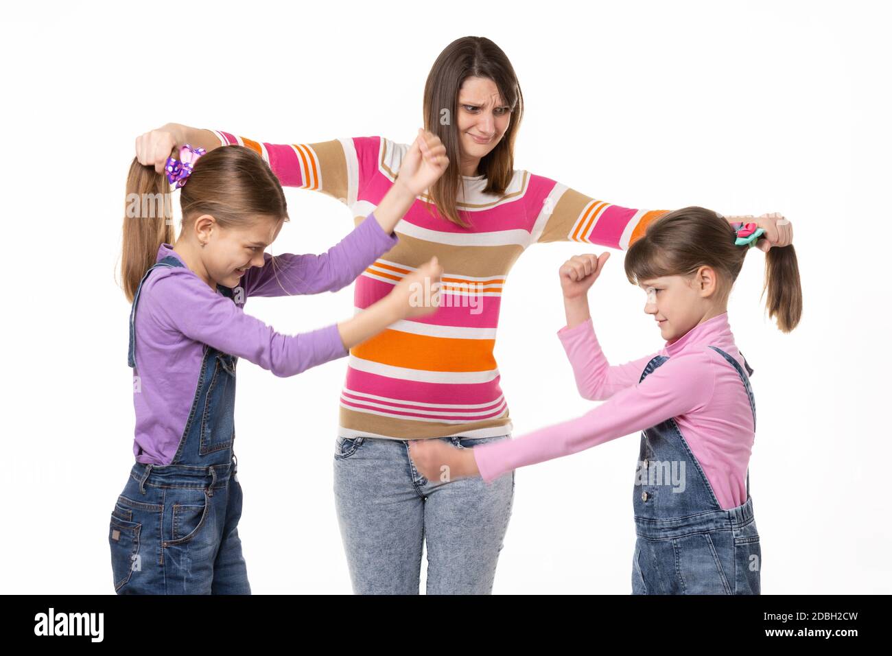 Mom and separate the two fighting daughters Stock Photo - Alamy