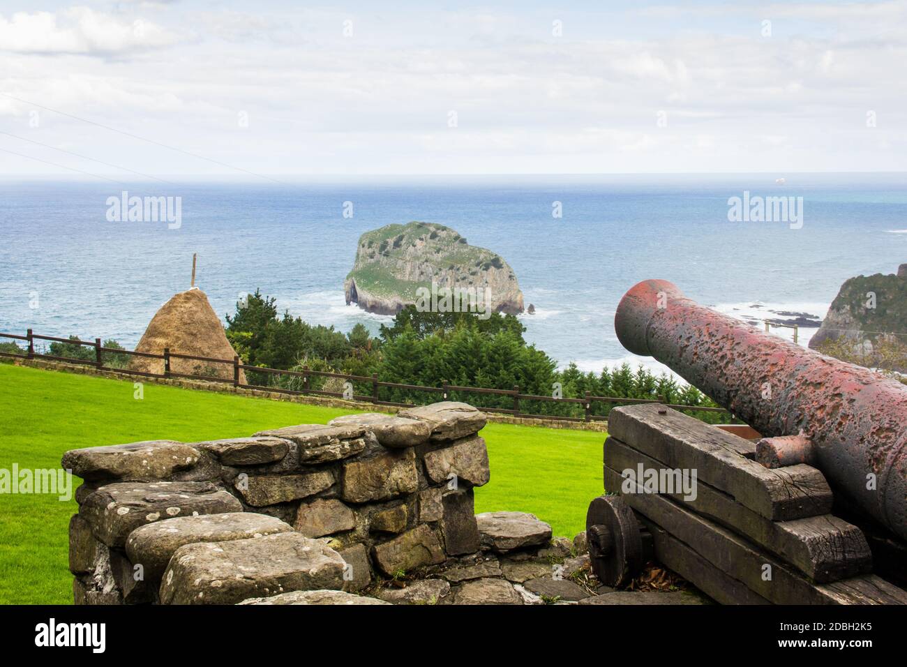 Old cannon pointing at island on the Basque coast, north Spain. Ancient ...