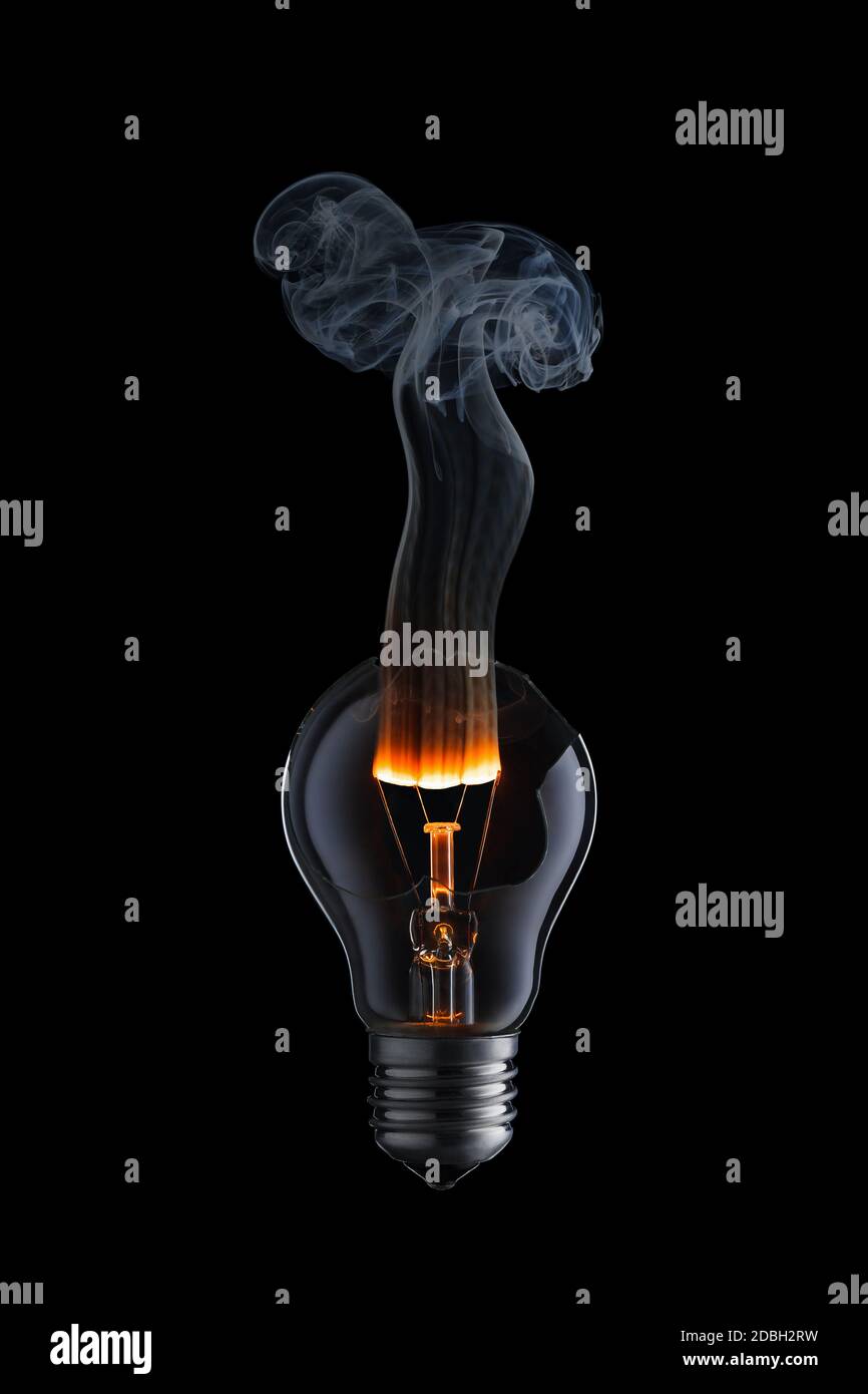 Light bulb with fire and smoke on black background Stock Photo - Alamy