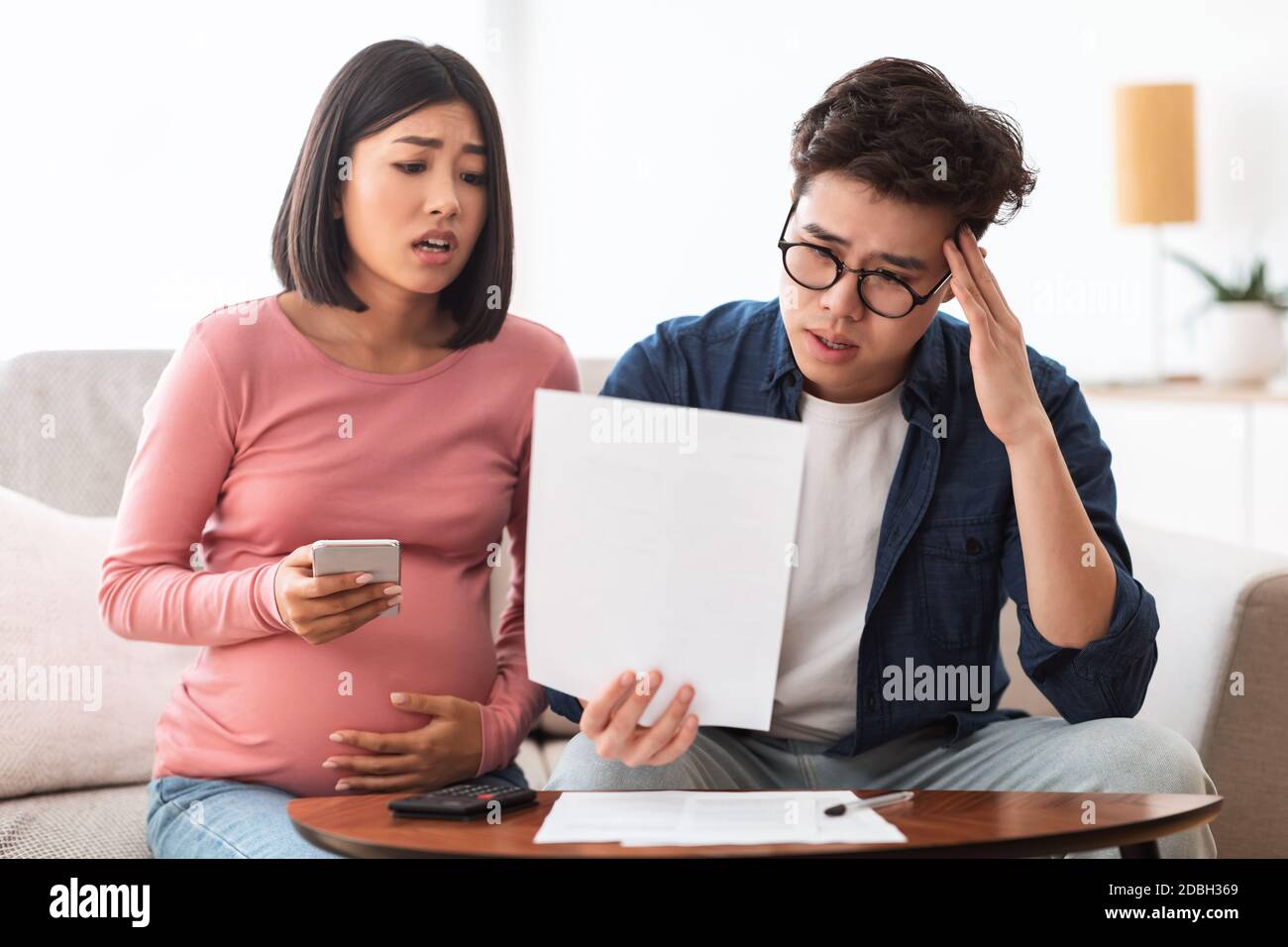 Depressed Japanese Couple Struggling Financial Crisis Looking At Bills ...