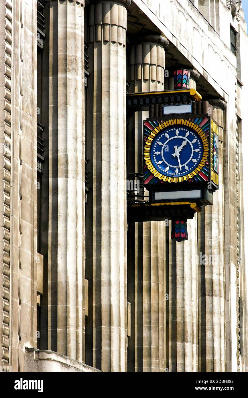 Colorful public clock at building with columns Stock Photo - Alamy