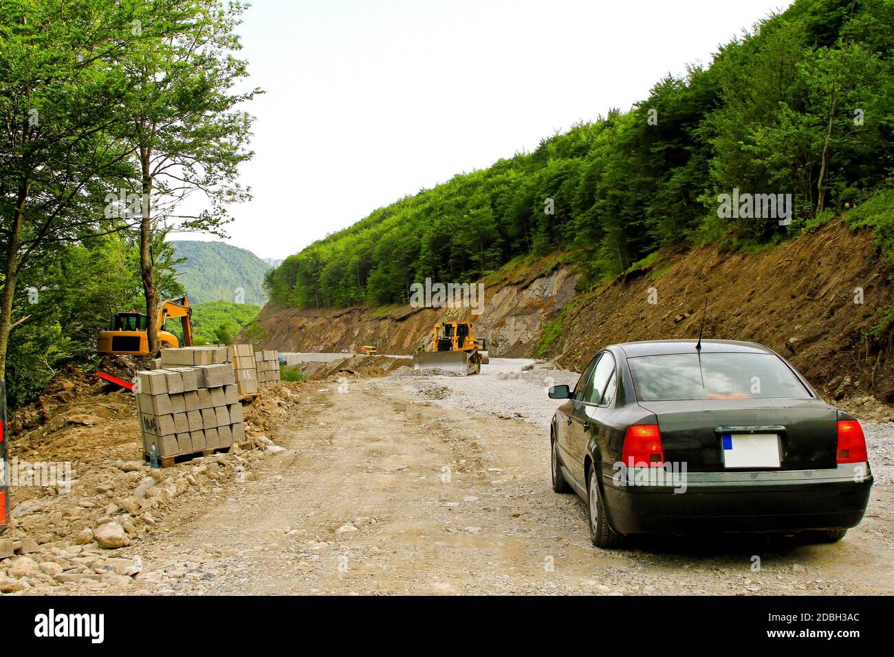 Mountain road works and heavy equipment construction Stock Photo - Alamy