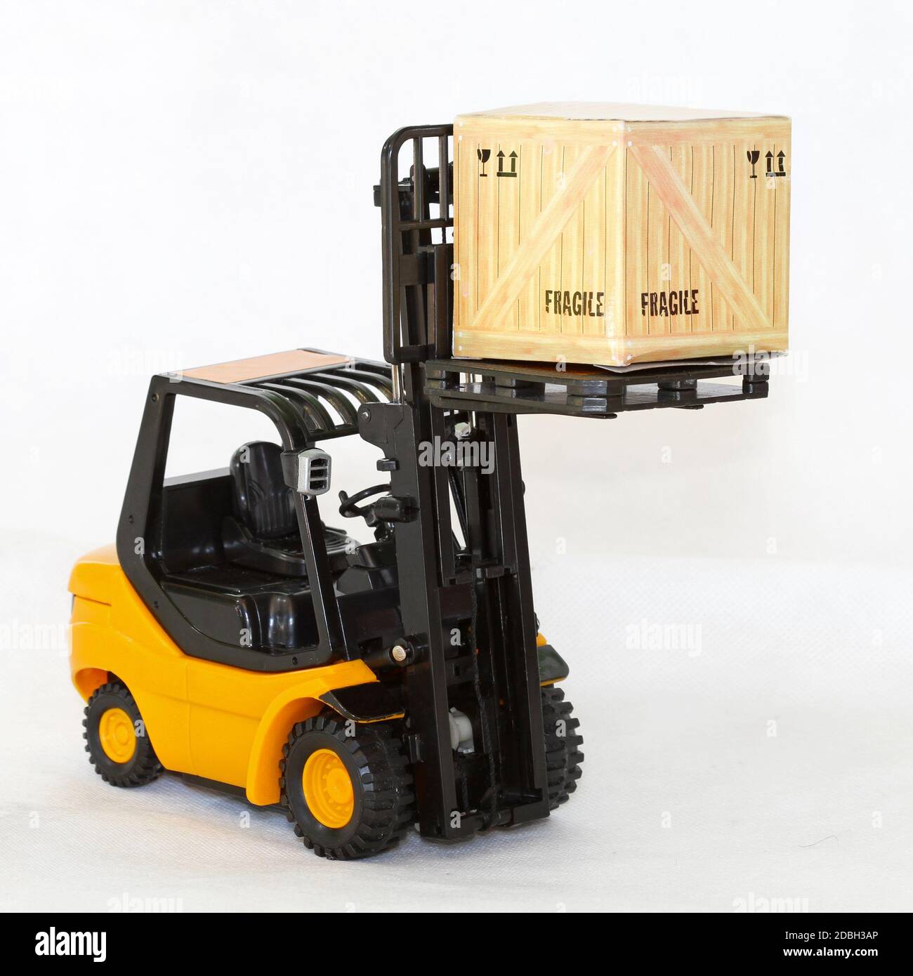 Miniature model of forklift with crate load Stock Photo - Alamy