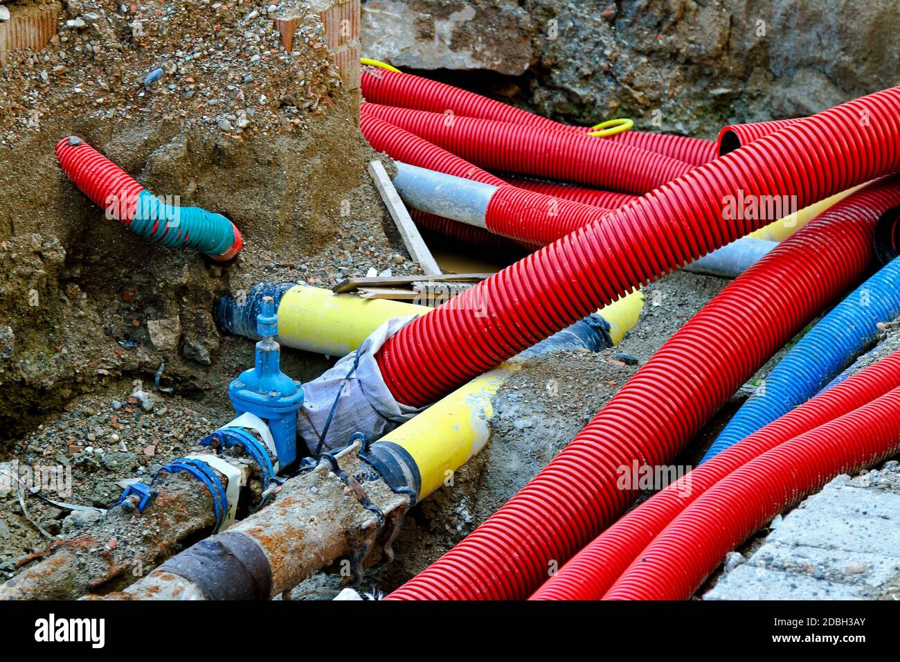 Underground construction of pipes hoses and cables Stock Photo - Alamy