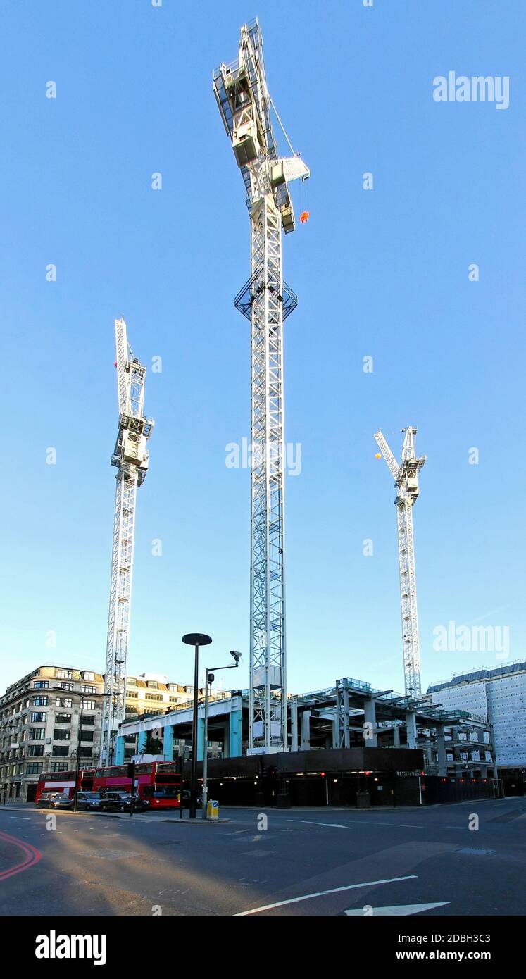 Very tall white cranes at construction site Stock Photo - Alamy